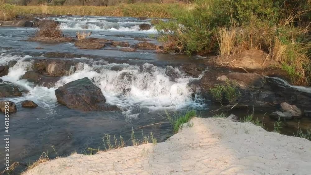 Multiple levels of a series of small waterfalls with water rushing down ...