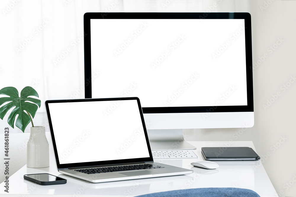 Mockup blank white screen laptop computer and desktop computer on white ...