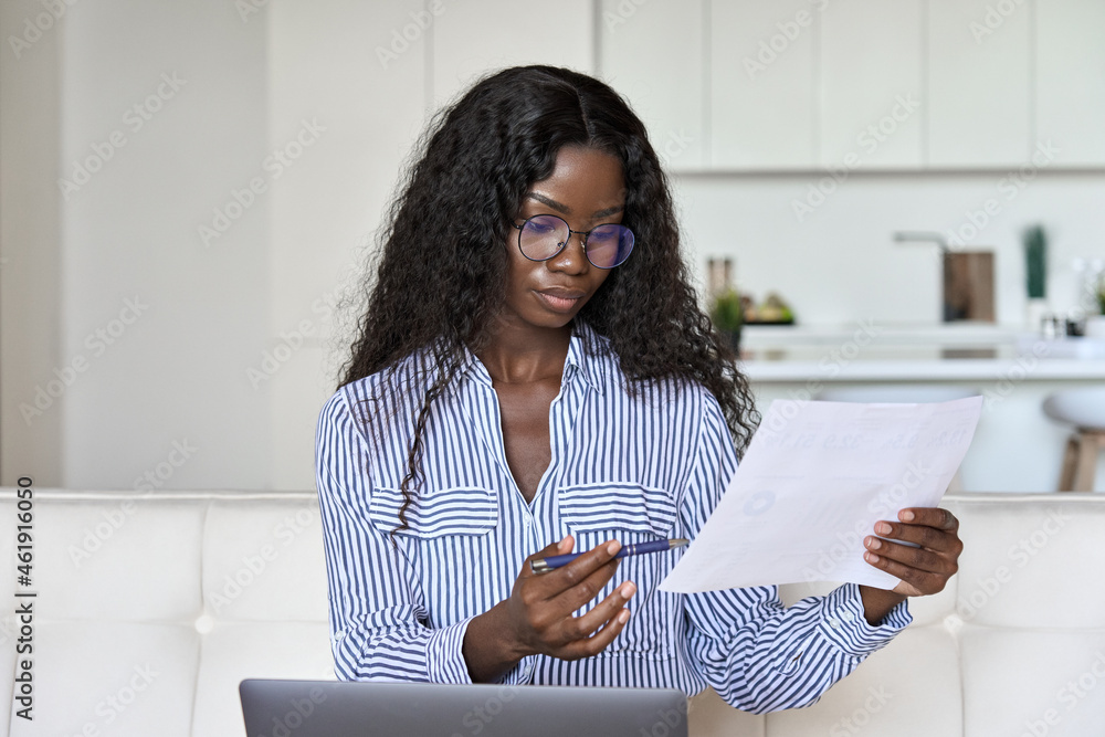 Serious young black African ethnic woman entrepreneur holding paper ...