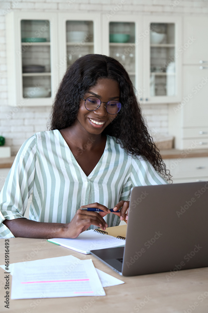 Young happy black woman student learning looking at laptop computer ...