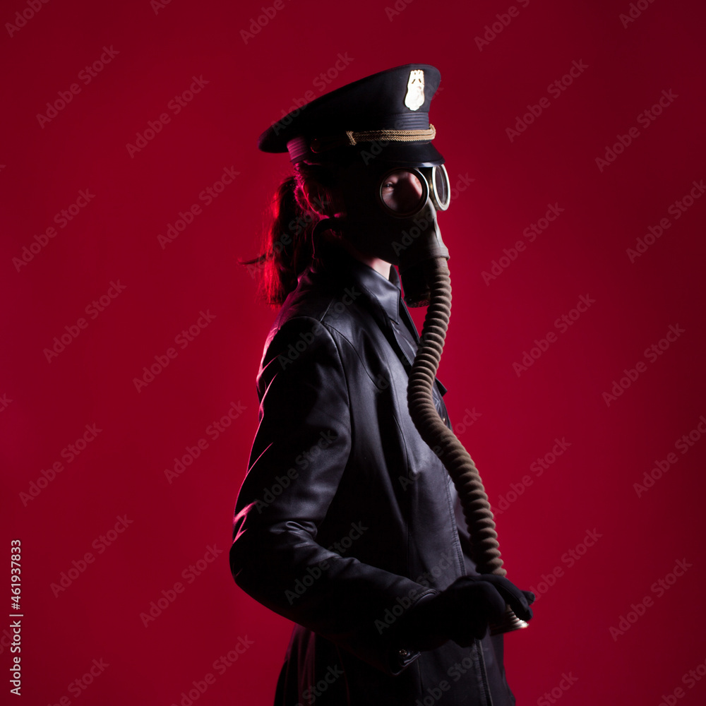 fantastic Nazi in black leather clothes and a cap with a gas mask on ...