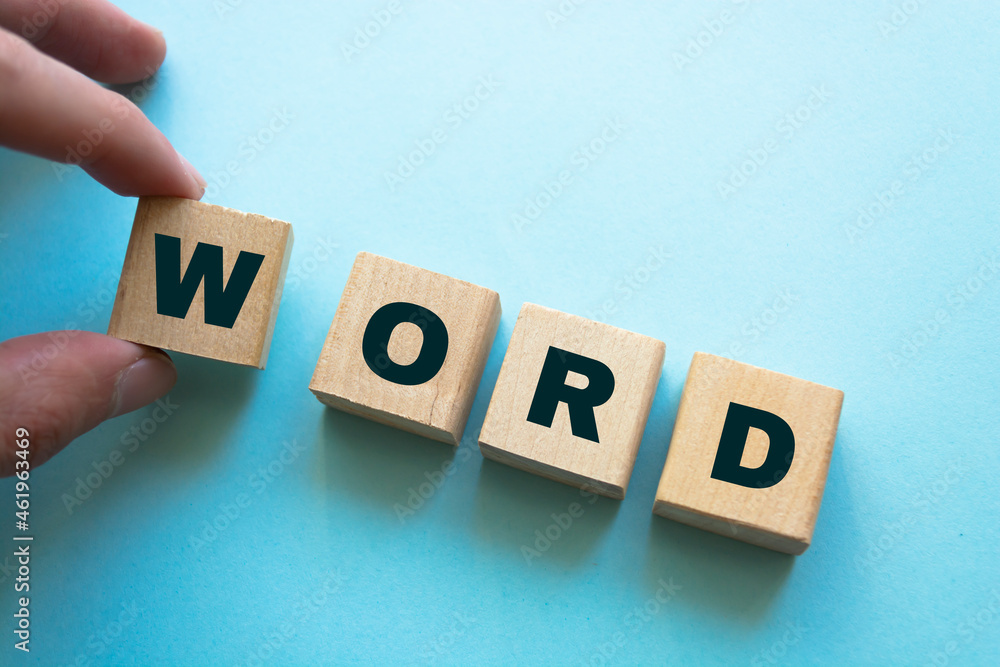 Man puts a wooden blocks with the inscription Word. The structural unit ...