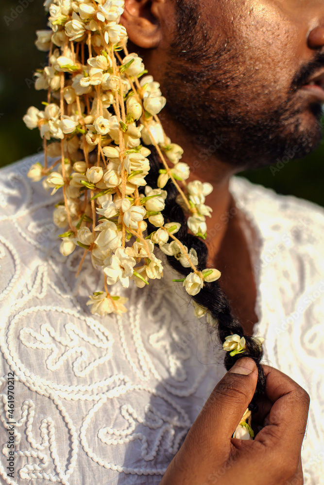 portrait of dark skinned Indian non-binary individual with traditional ...