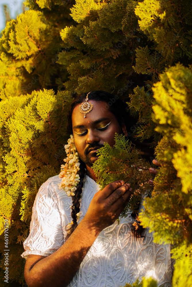 portrait of dark skinned Indian non-binary individual with traditional ...