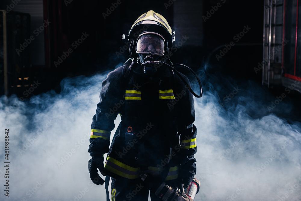 Portrait of a female firefighter wearing a helmet and all safety ...