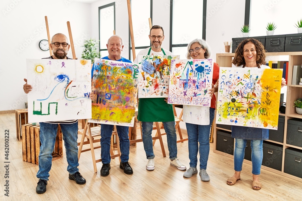 Group of middle age draw students smiling happy holding drawing canvas ...