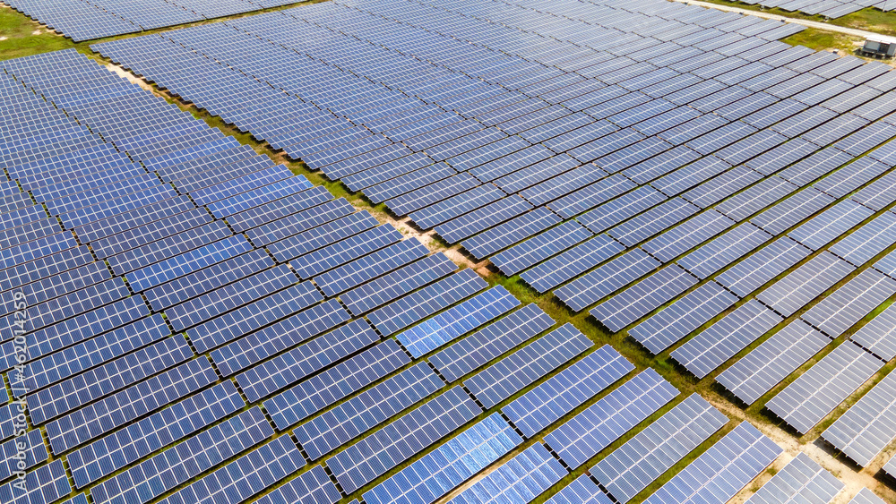 Aerial view of a large scale solar panel farm. It harvesting sun's ...