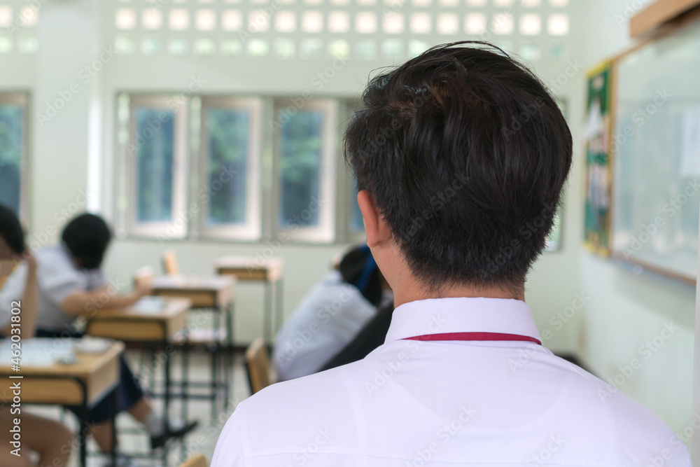 Behind Smart Asian teacher looking all students highschool in exam ...