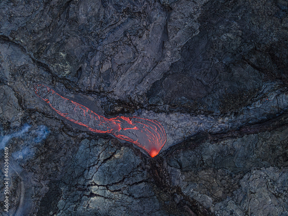 viewed from above on red-orange lava flow on cooled lava after volcanic ...