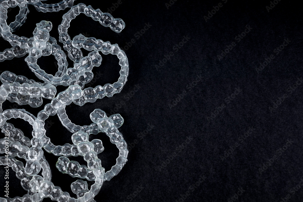 Transparent invisalign retainers brackets on black background. Dental ...
