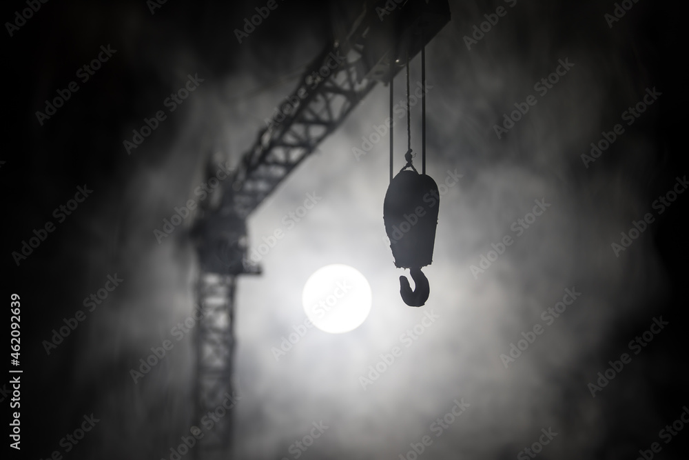 Abstract Industrial background with construction crane silhouette over ...