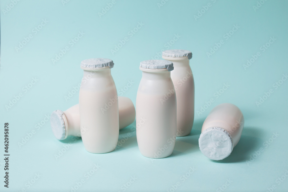 Bottles with probiotics and prebiotics dairy drink on light blue ...