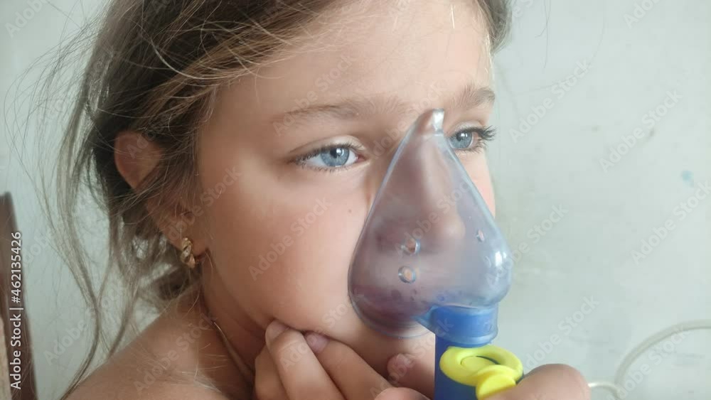 Little girl child doing therapeutic inhalation with a nebulizer Stock ...