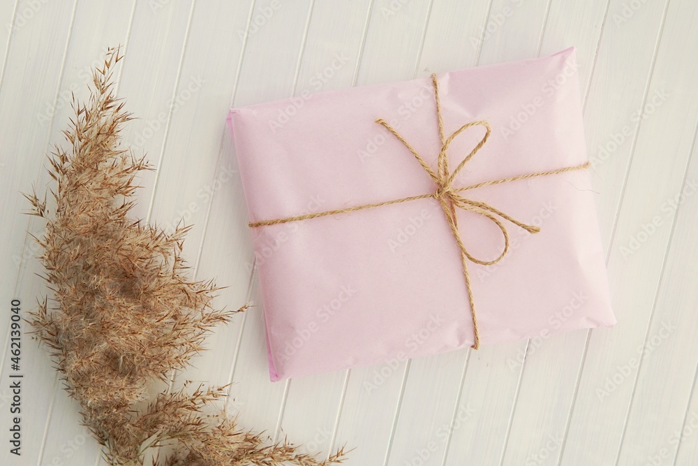 Pink wrapping paper package with ribbon, mockup for thank you sticker ...