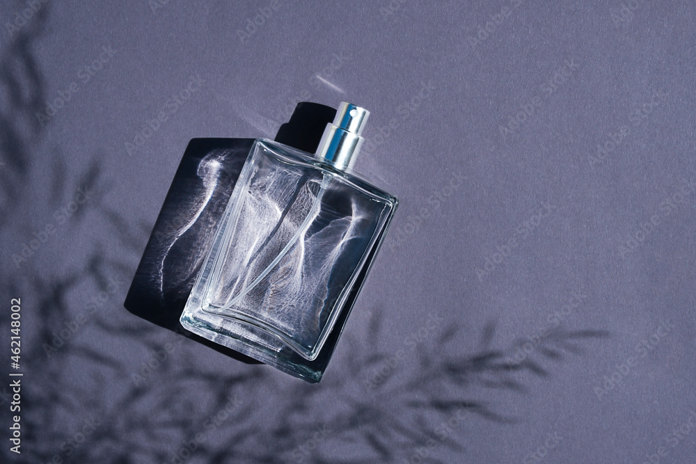 Transparent bottle of perfume on a dark grey background. Fragrance ...