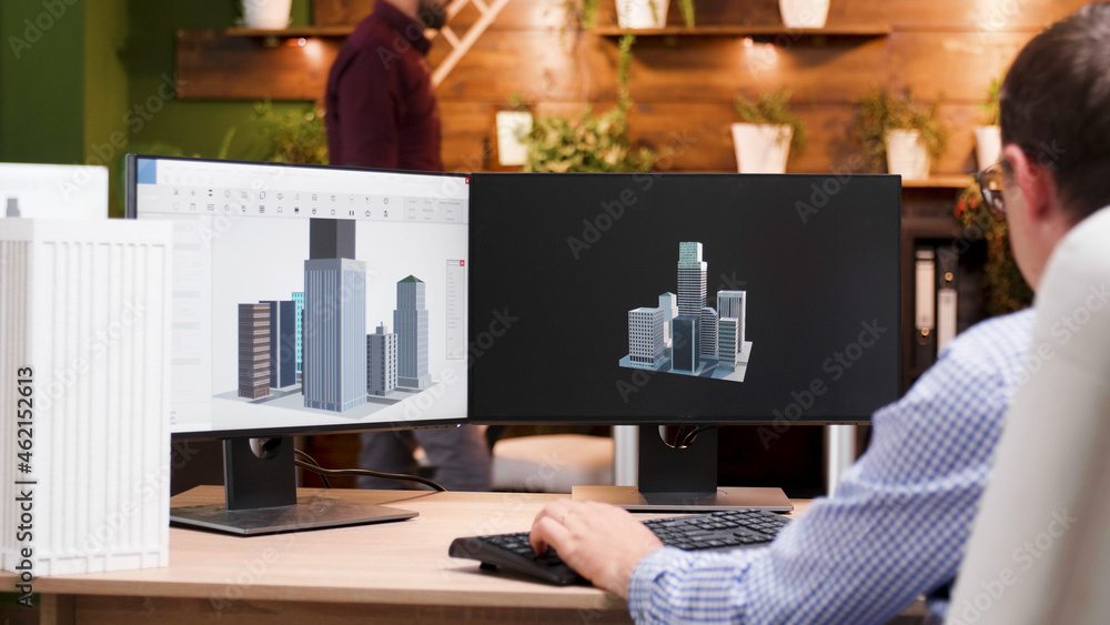 Engineer man working at architectural building prototype on computer ...