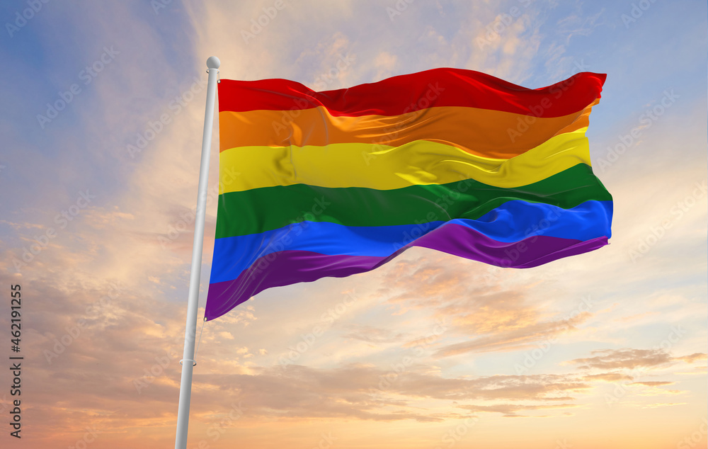 Gay Pride flag waving in the wind at cloudy sky. Freedom and love ...