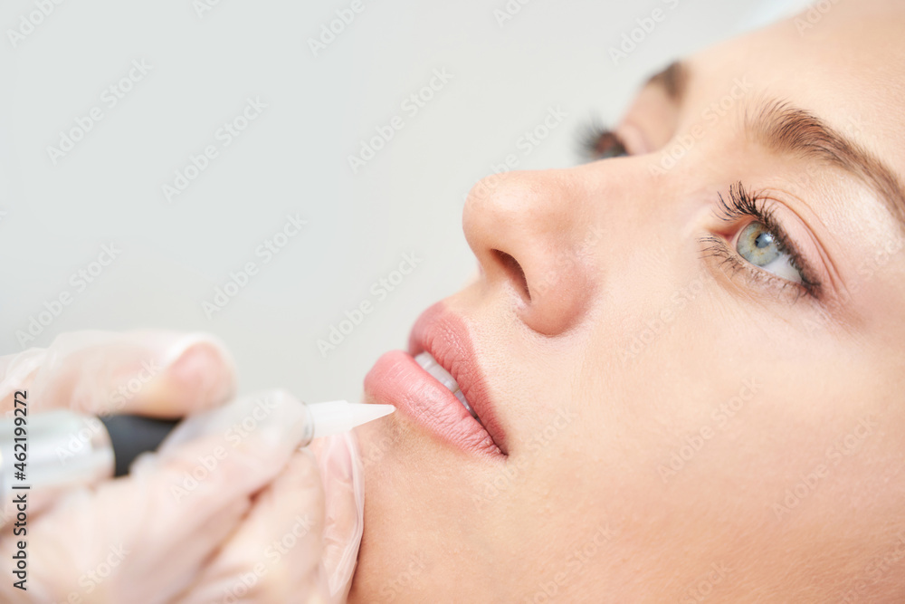 Permanent makeup. Beauty spa procedure. Beauty young woman. Lip tattoo ...