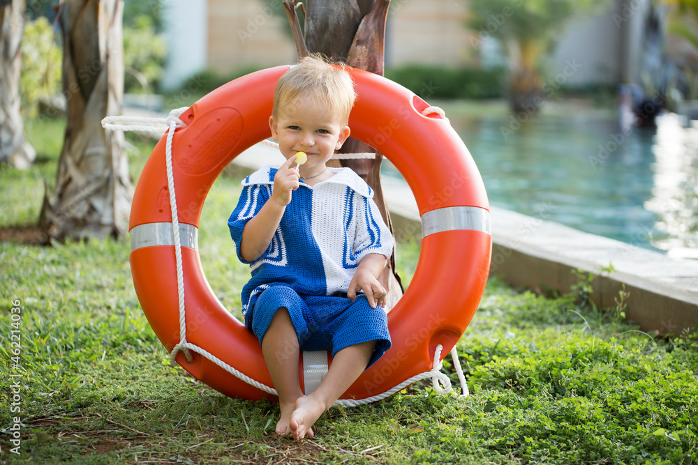 Boy child playing with lifebuoy. Baby care and childhood concept. Stock ...