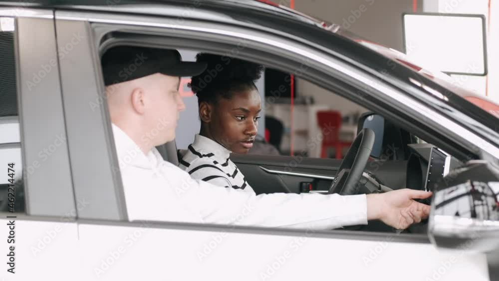 Black woman test driving her brand new car that she bought at the car ...
