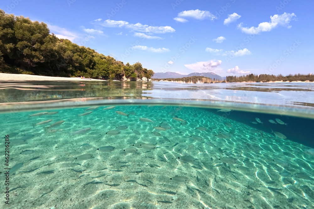 Underwater split photo of famous bay and sandy turquoise beach of ...