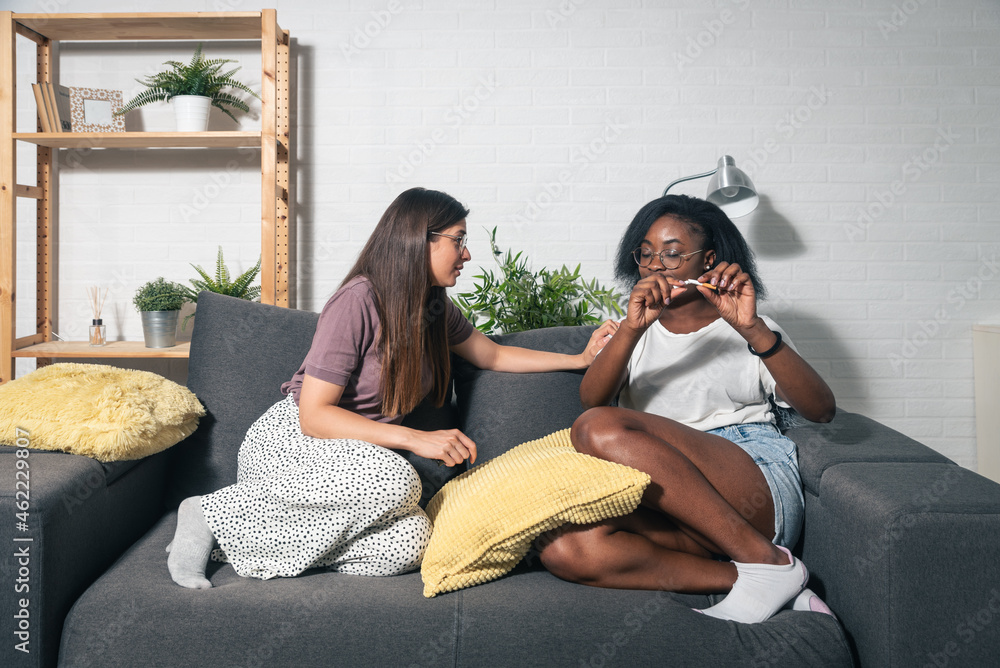 Young lesbian homosexual couple sitting at home make a deal about ...