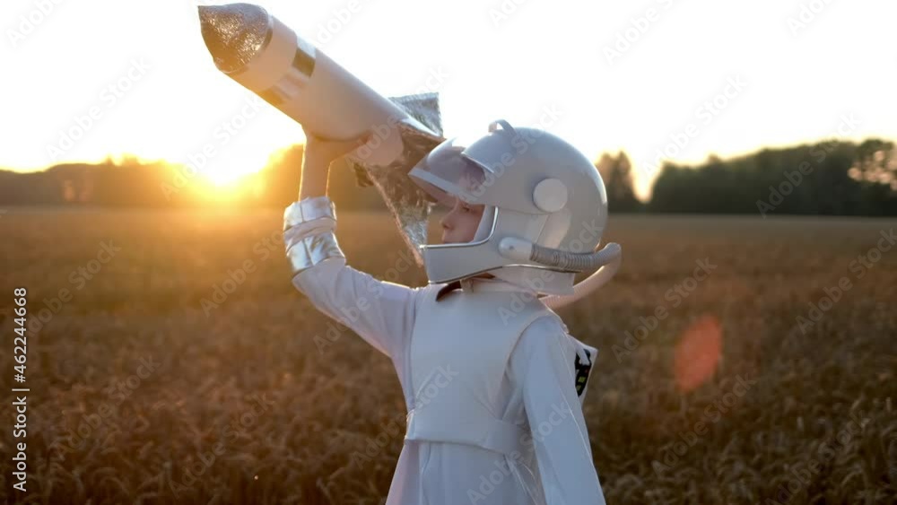 Little young happy cute child boy wearing astronaut uniform and helmet ...