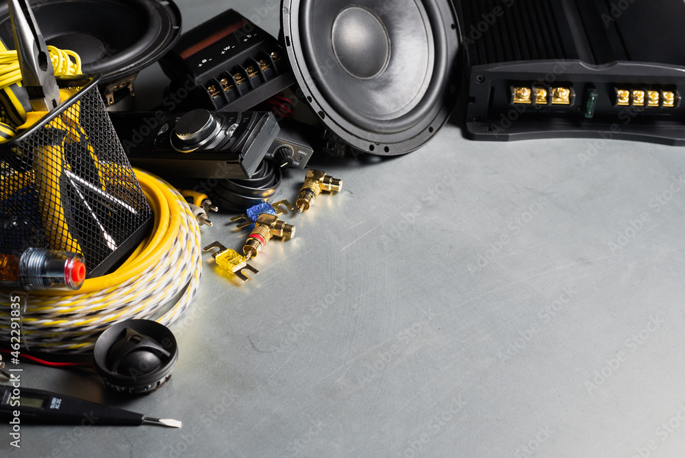 Car stereo system components and work tools on the metal workbench ...