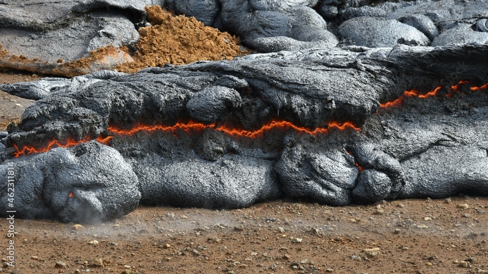 Pahoehoe lava flow at Fagradalsfjall, Iceland. Lava crust is gray and ...