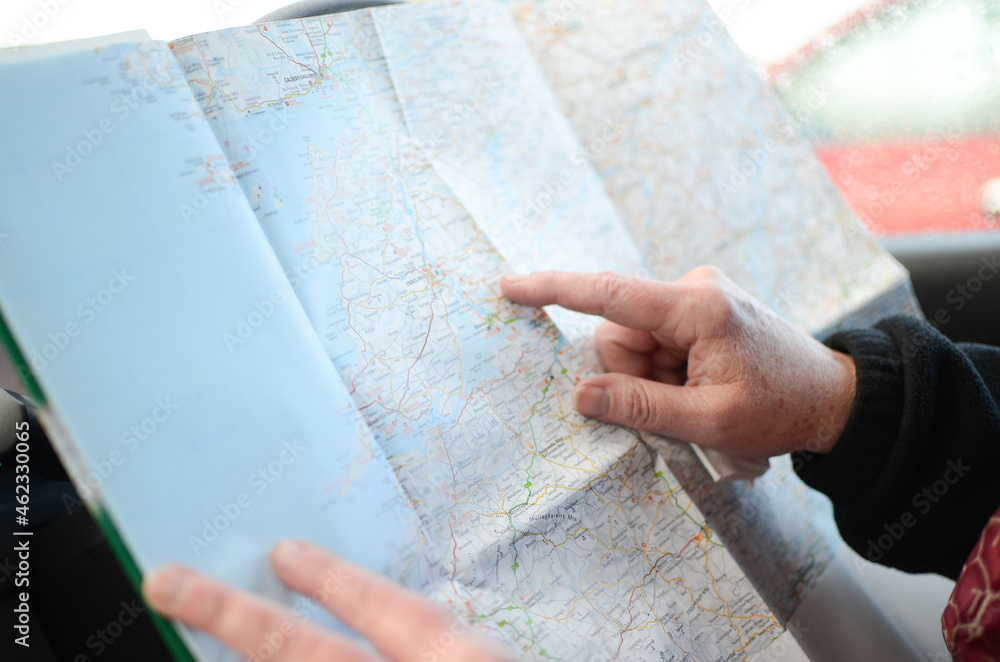 Older woman uses a paper map of Ireland to navigate her travels Stock ...