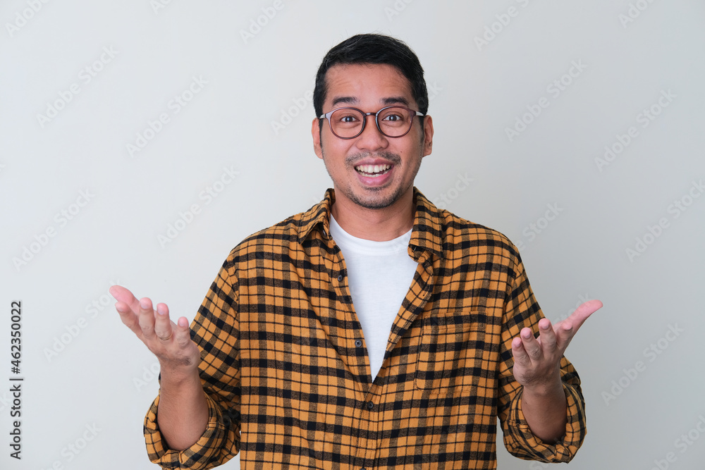 Adult Asian man showing cheerful face expression with both hands open ...