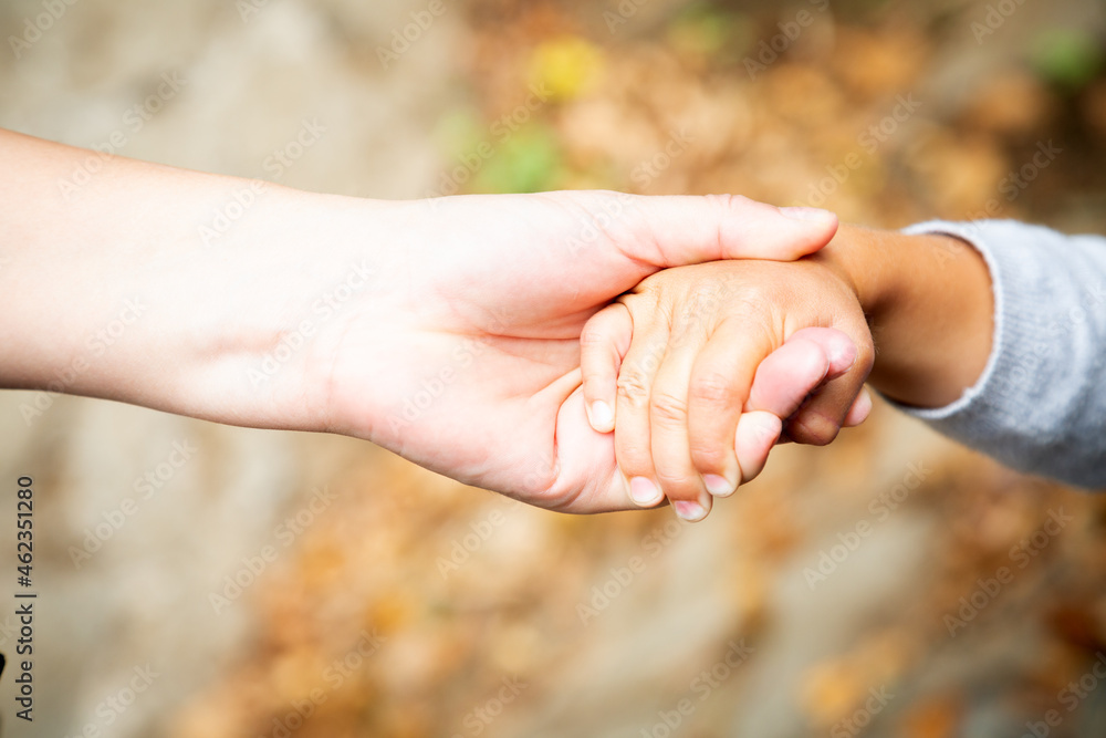 Mom holds hand of her child. Parental support, help concept. Family ...