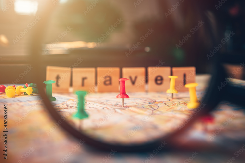 A magnifying glass with pins pinned on the map. pushpin showing the ...