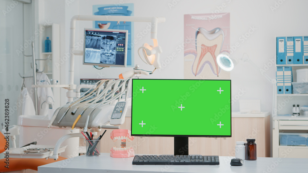 Nobody in dentist office with horizontal green screen on computer and ...