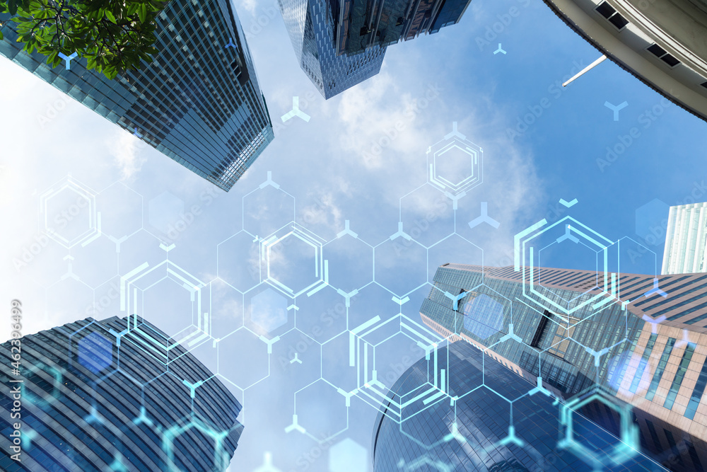 Technology hologram over low angle shot of Singapore skyscrapers. The ...