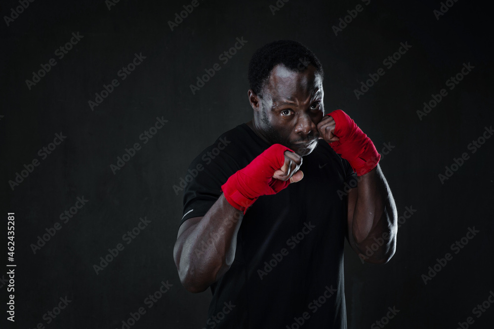 Sporty man during boxing hit. African american muscular athlete in ...
