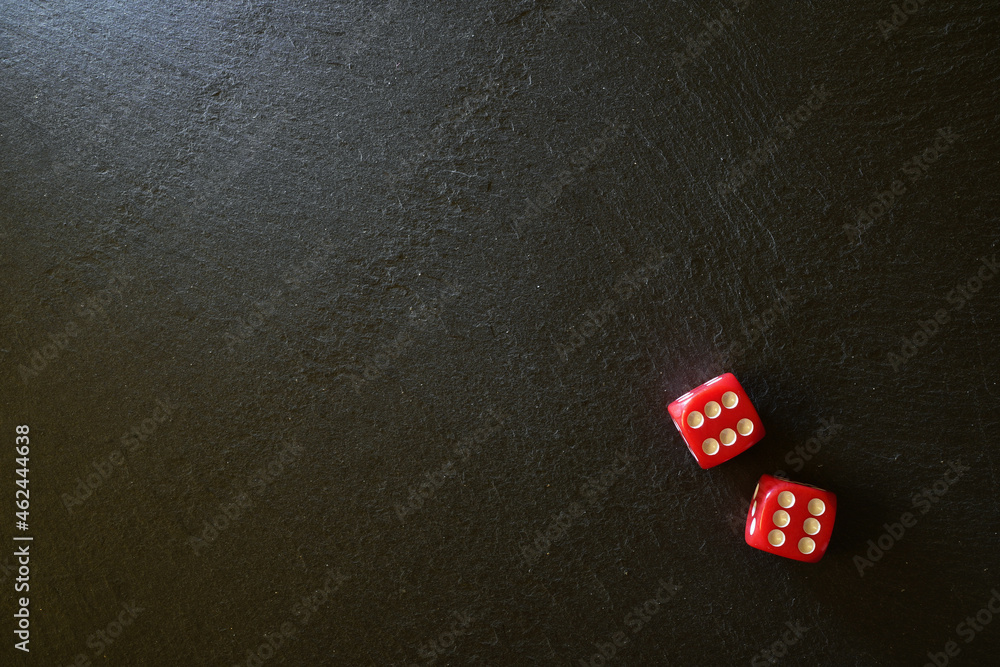 The two red dice with the highest score lie on a black stone surface ...