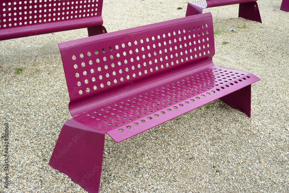 Urban furniture in a park. Modern metal bench in violet color. Metallic ...