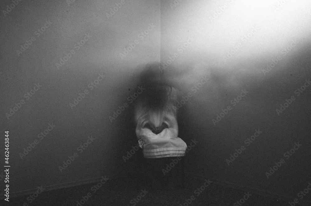 Ghost girl sitting in dark foggy corner of haunted house Stock Photo ...