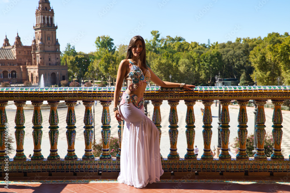 beautiful young belly dancer is posing for the camera in a photo shoot ...