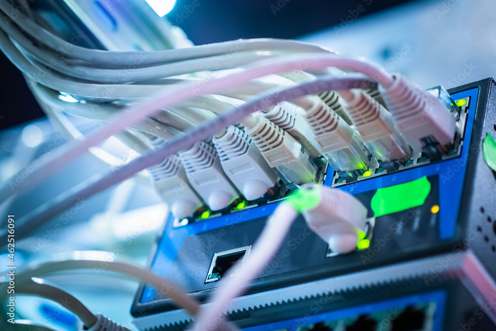 Network cables connected to hub. Optic fiber cables connected to data ...