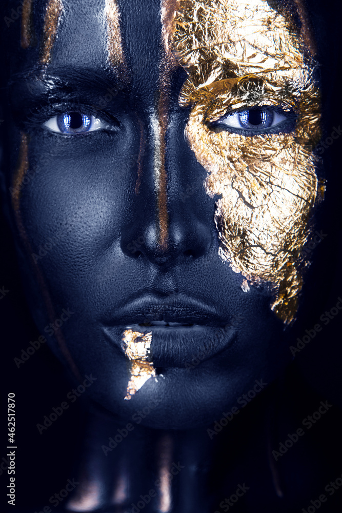 fashion portrait of a blue-skinned girl with gold make-up. Beauty face ...