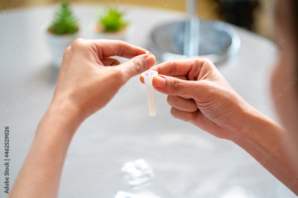 Asian woman using rapid antigen test kit for self test COVID-19 ...