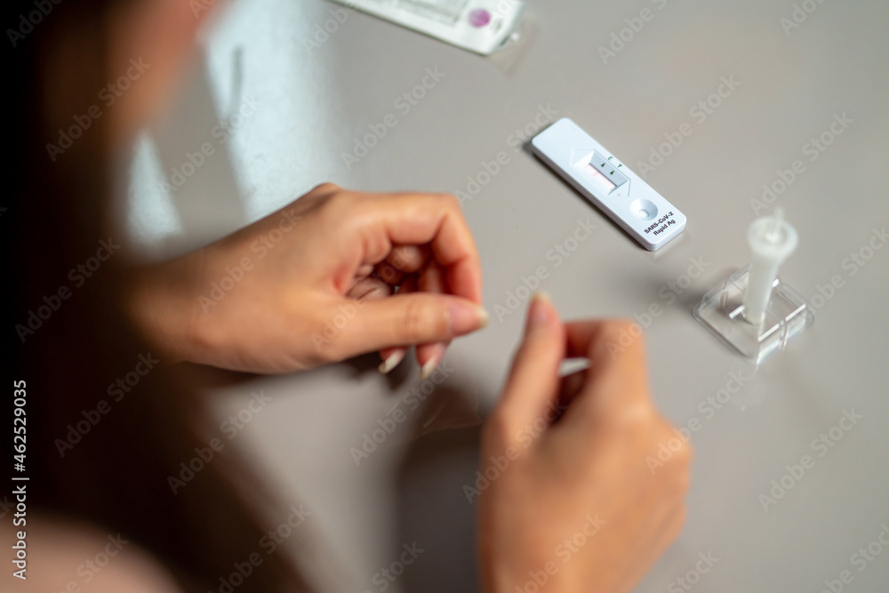 Asian woman using rapid antigen test kit for self test COVID-19 ...