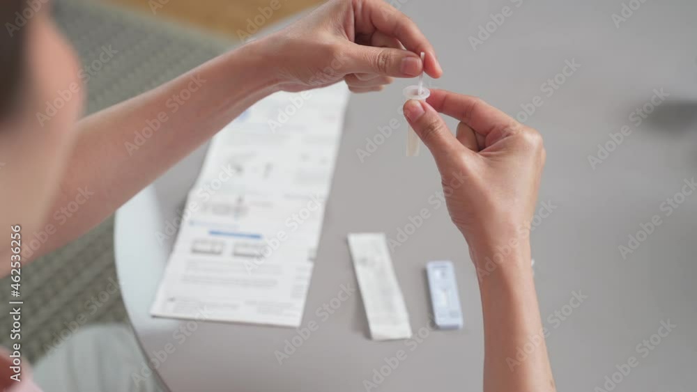 Asian woman using rapid antigen test kit for self test COVID-19 ...