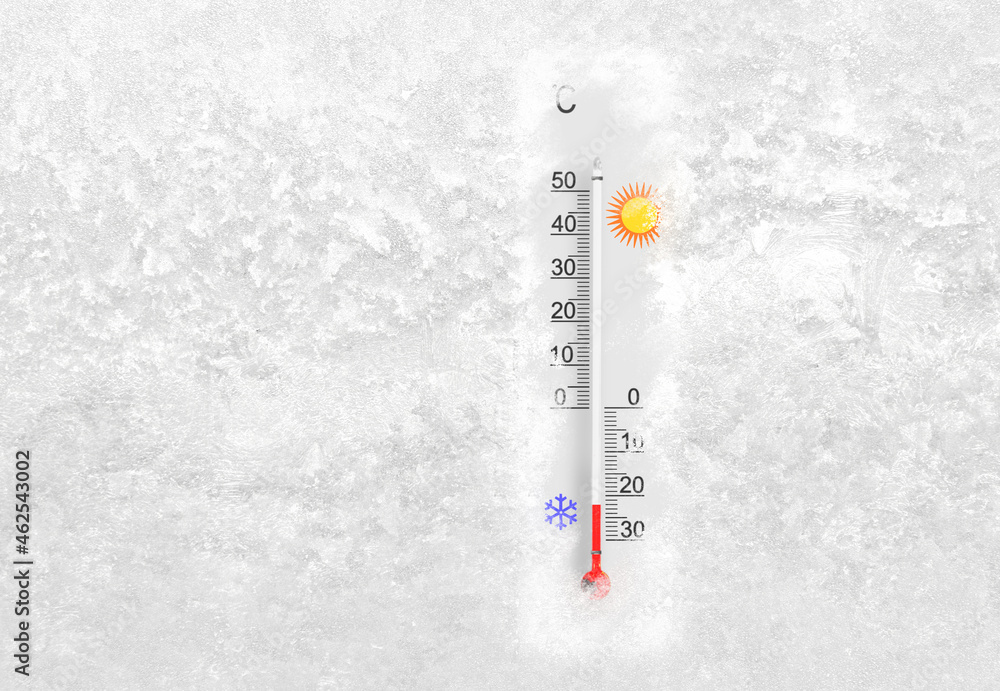 Outdoor thermometer on a frozen window shows minus 22 degrees celsius ...