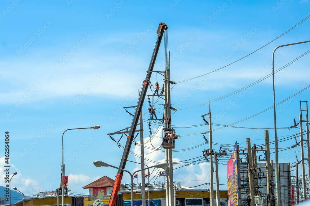 Repairing high voltage poles on the crane work at height risk Stock ...
