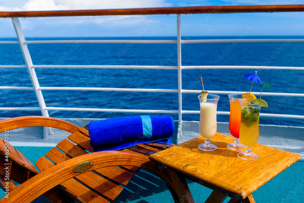 Sun loungers to enjoy the ocean views, with a cocktail table next to it ...