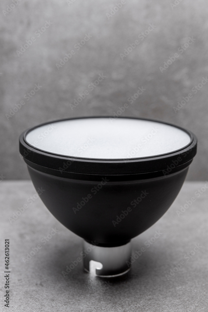 Vertical frame with small speedlite flash light modifier reflector and ...