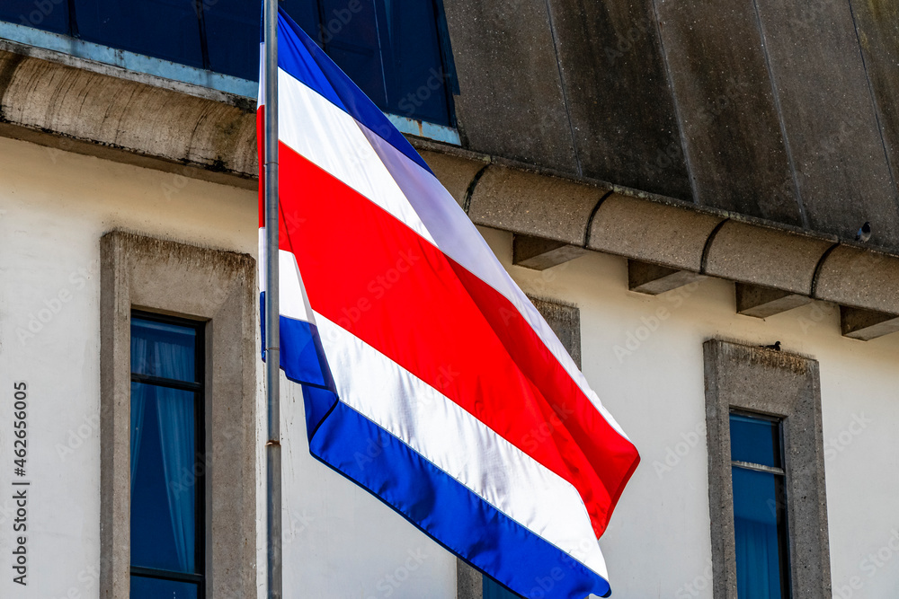 Flag of Costa Rica old buildings behind Costa Rican flag. Stock Photo ...